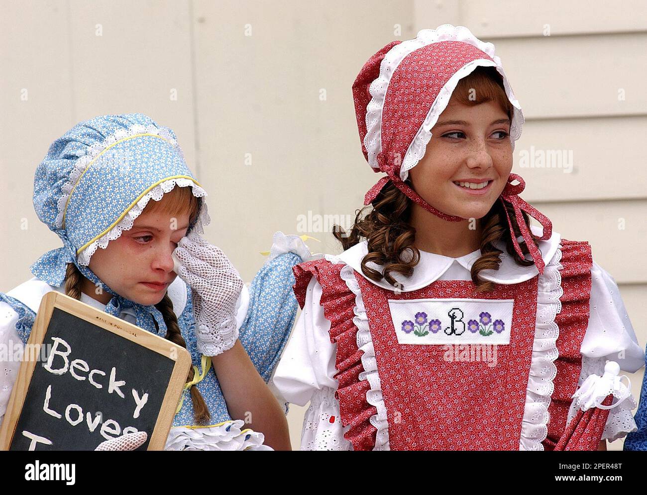 Kaitlin Bible, left, wipes away a tear as she passes her official ...