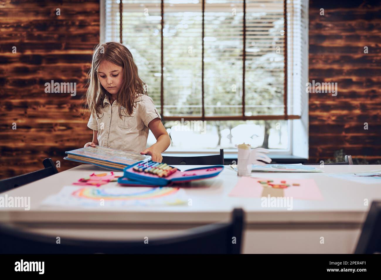 Girl doing homework, learning, drawing pictures, doing puzzles in ...