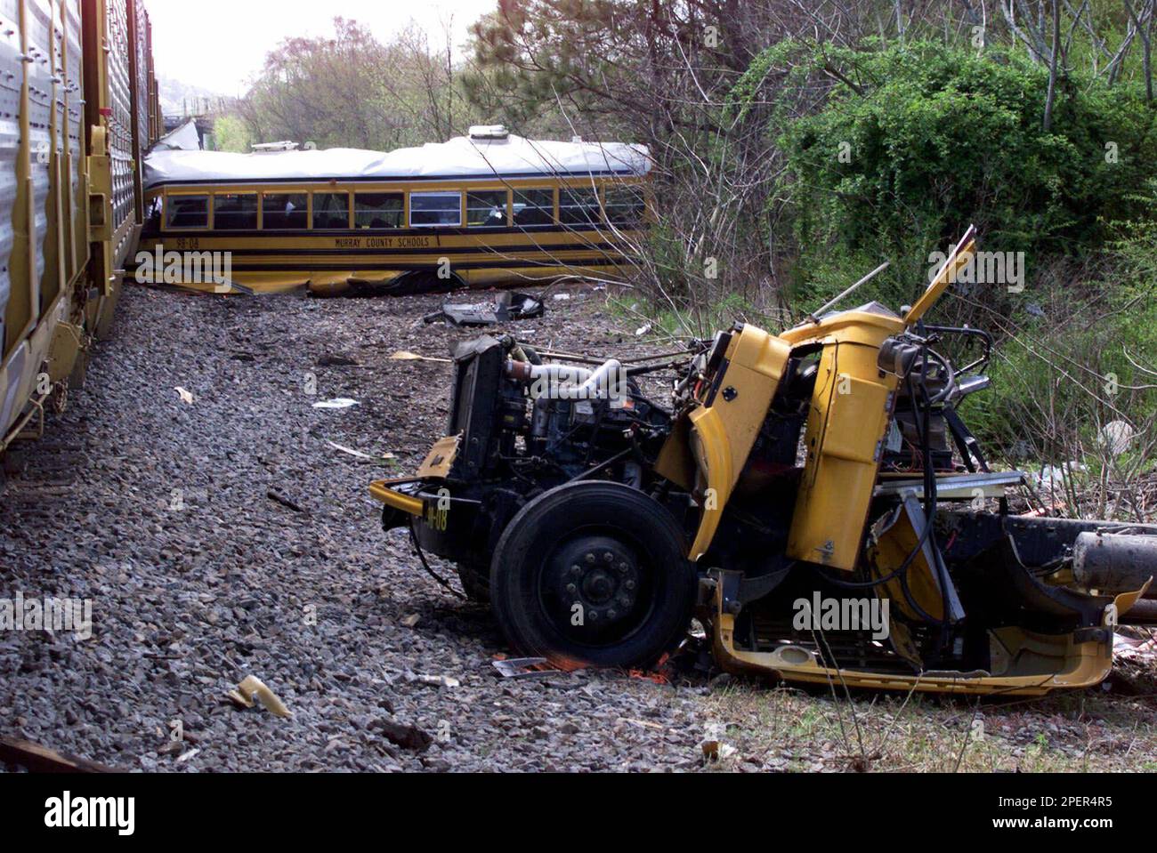 ** FILE ** The body of a bus carrying seven children and the driver ...