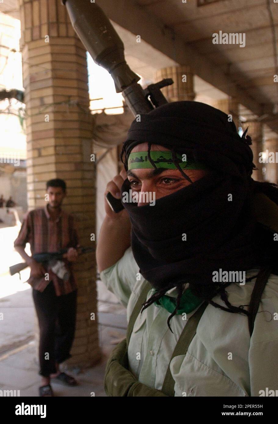 A fighter loyal to Radical Shiite cleric Muqtada al-Sadr looks toward ...