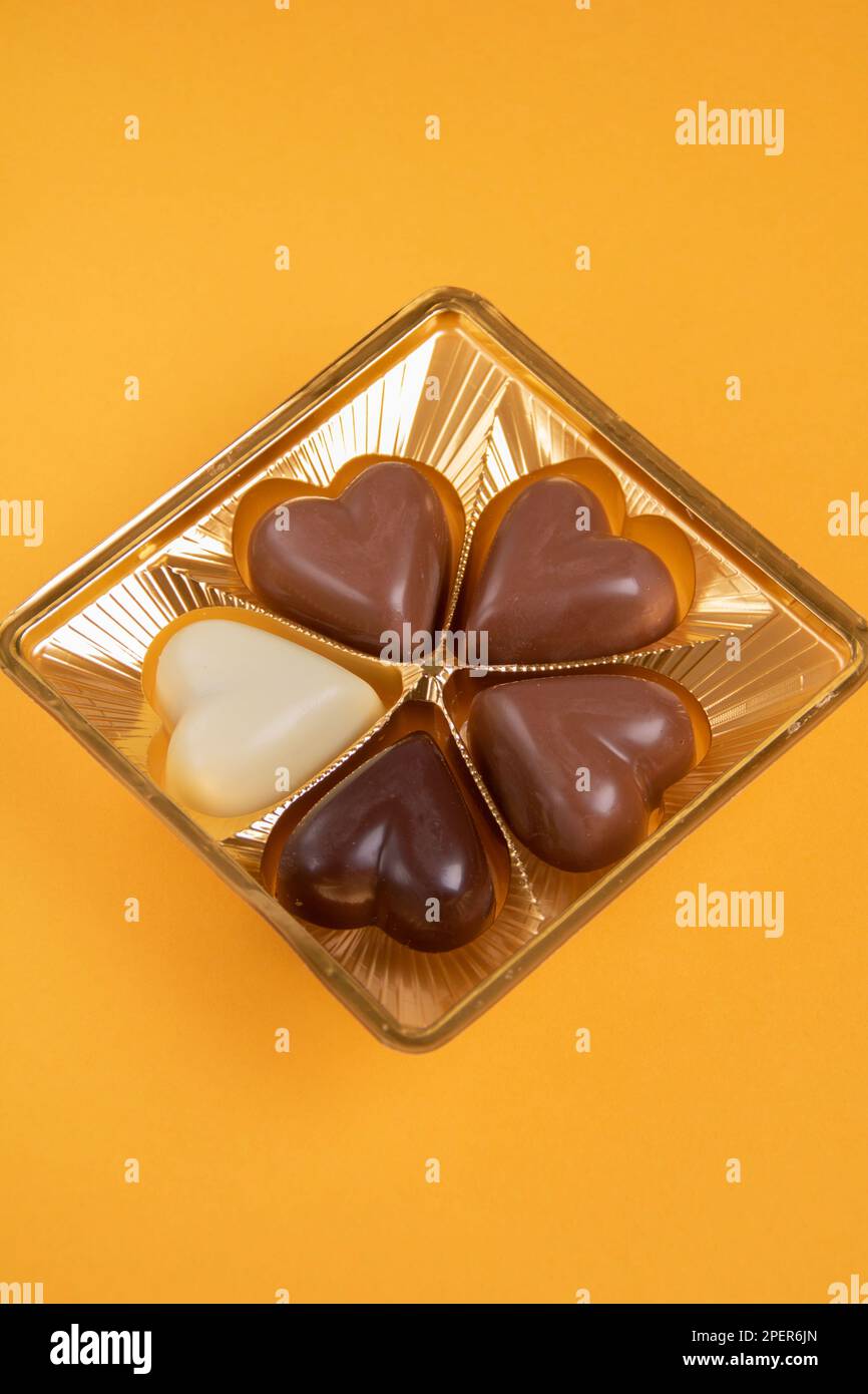 photo package of different flavors of chocolate on a yellow background ...