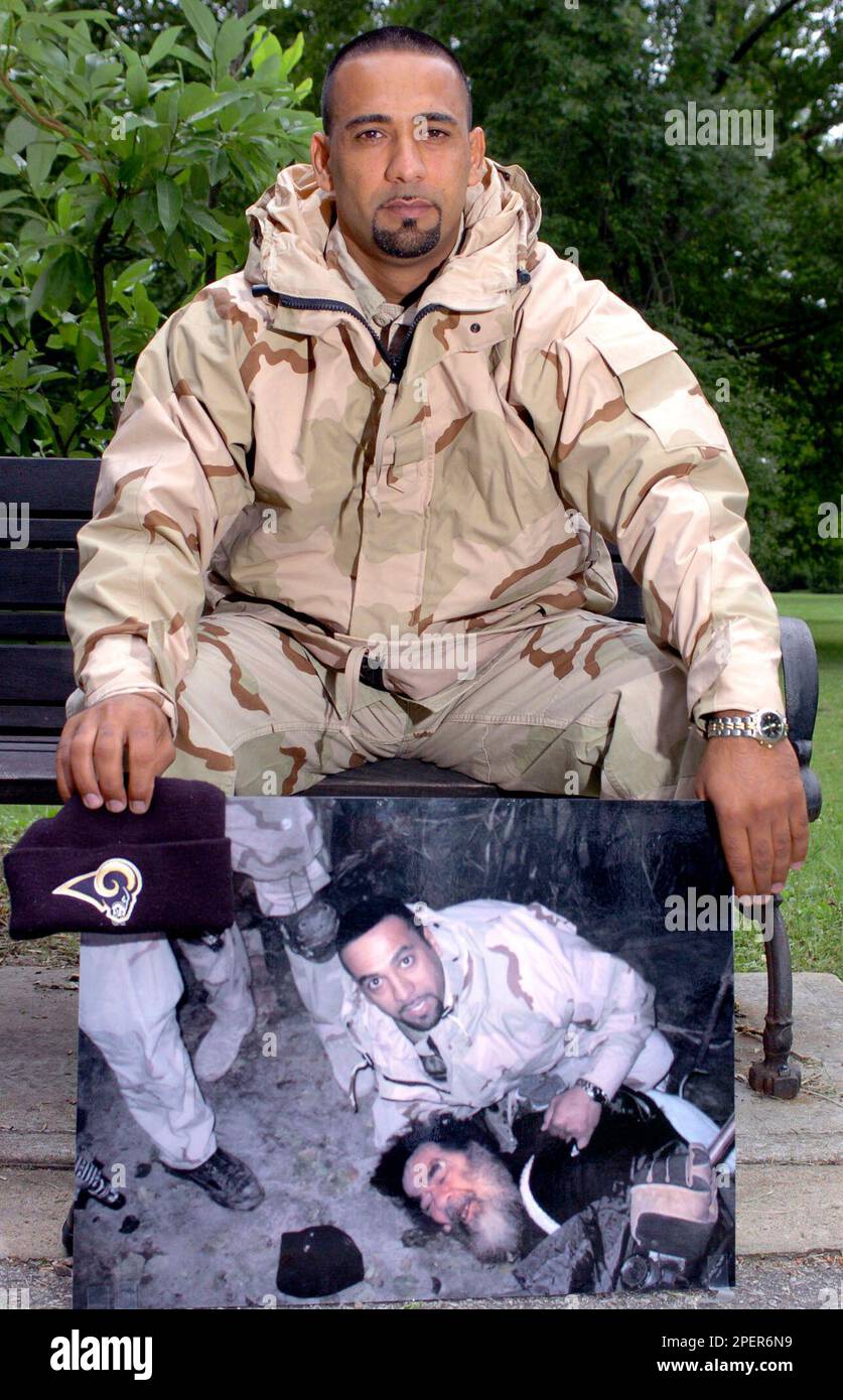 Iraqi-American, Samir, 34, holds a picture of him pinning deposed Iraqi ...