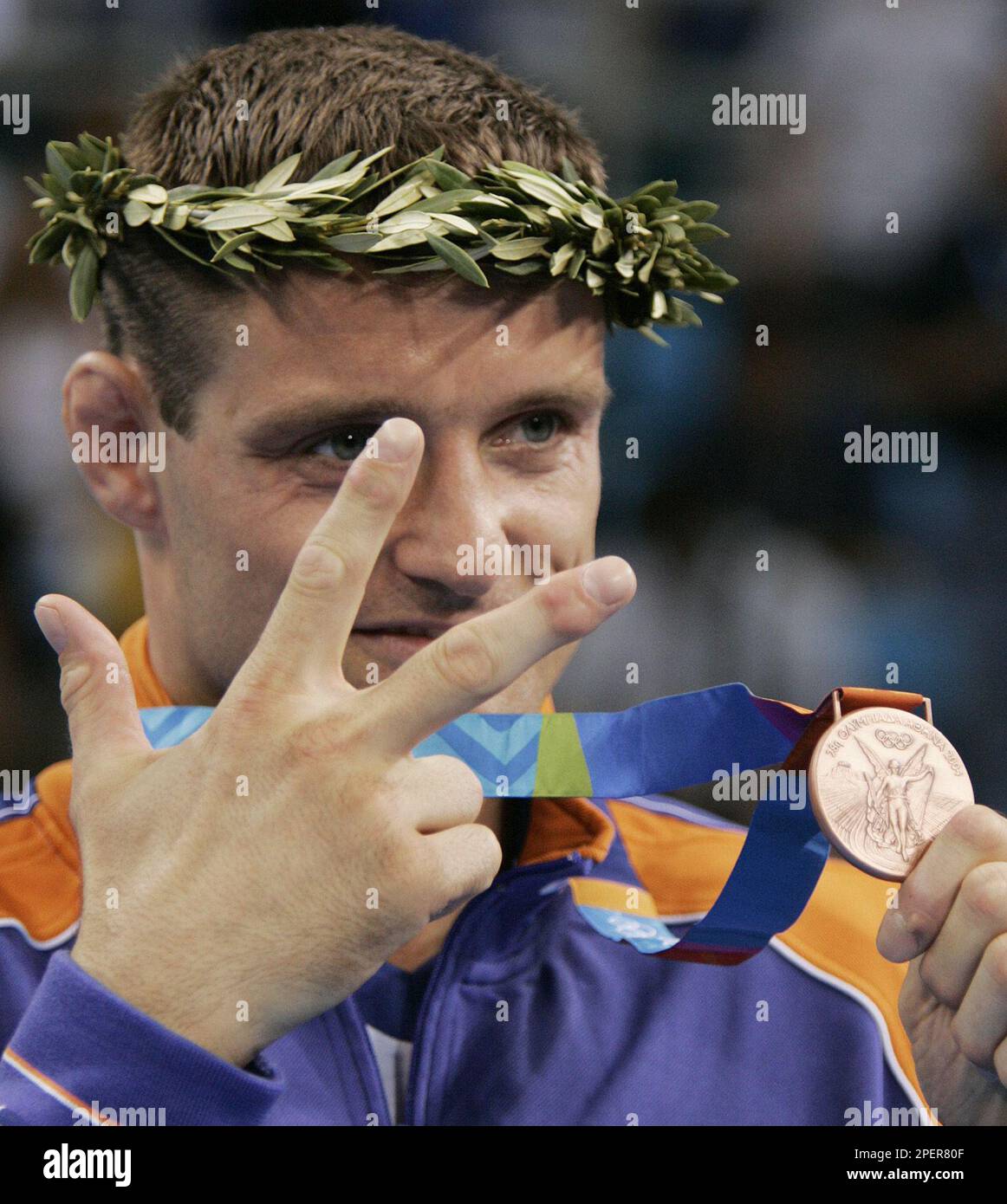 Mark Huizinga of the Netherlands shows the bronze medal on the podium ...