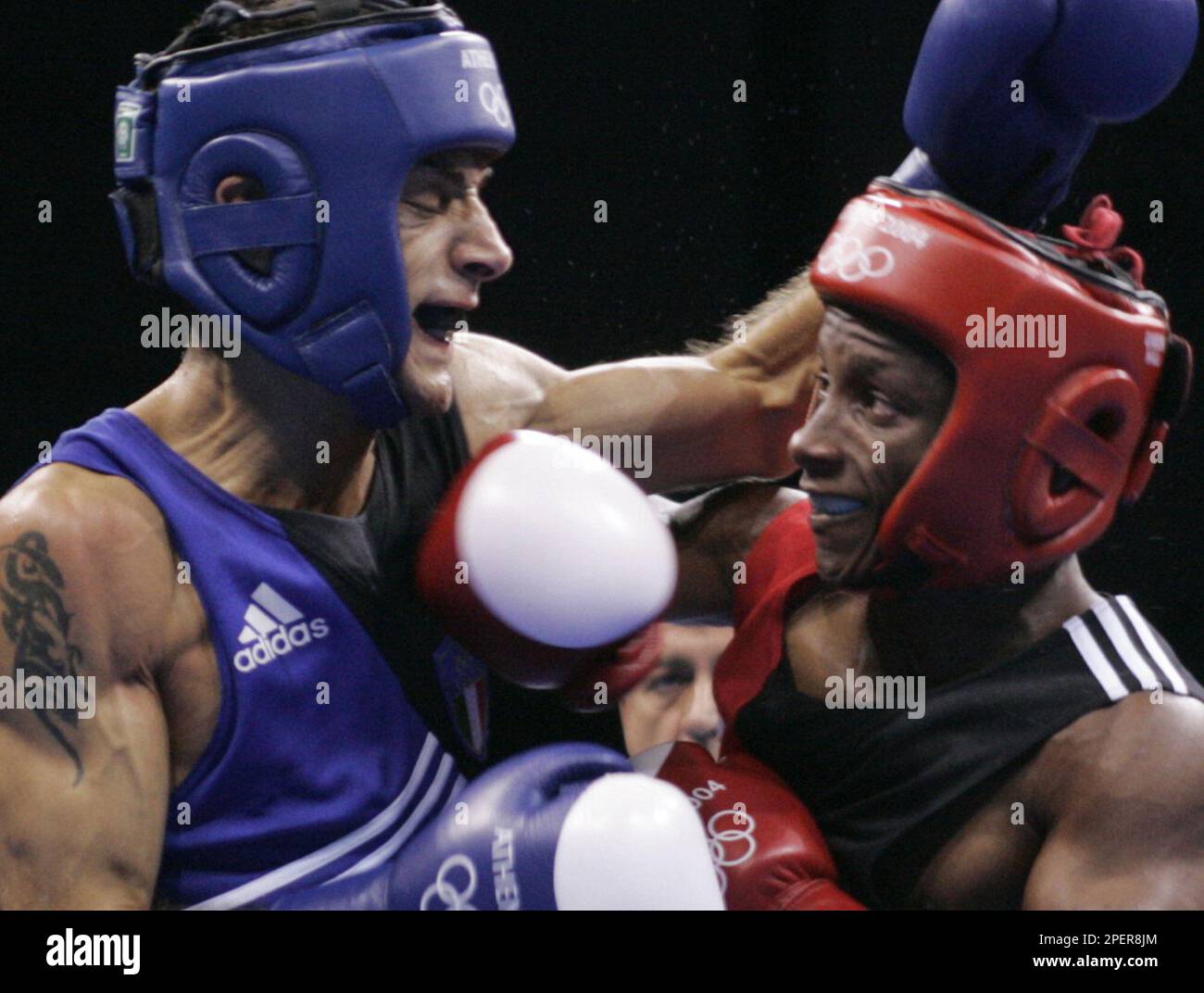Nigeria's Effiong Okon, right, throws a blow on Italy's Alfonso Pinto ...