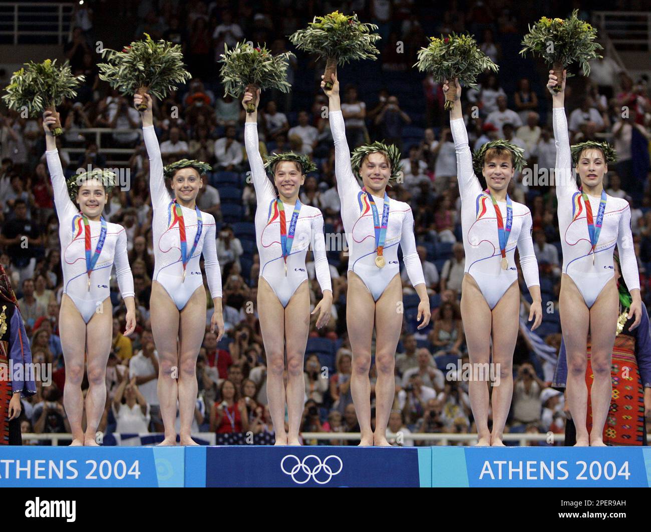 The Romanian women's gymnastics team celebrates their gold medal win ...