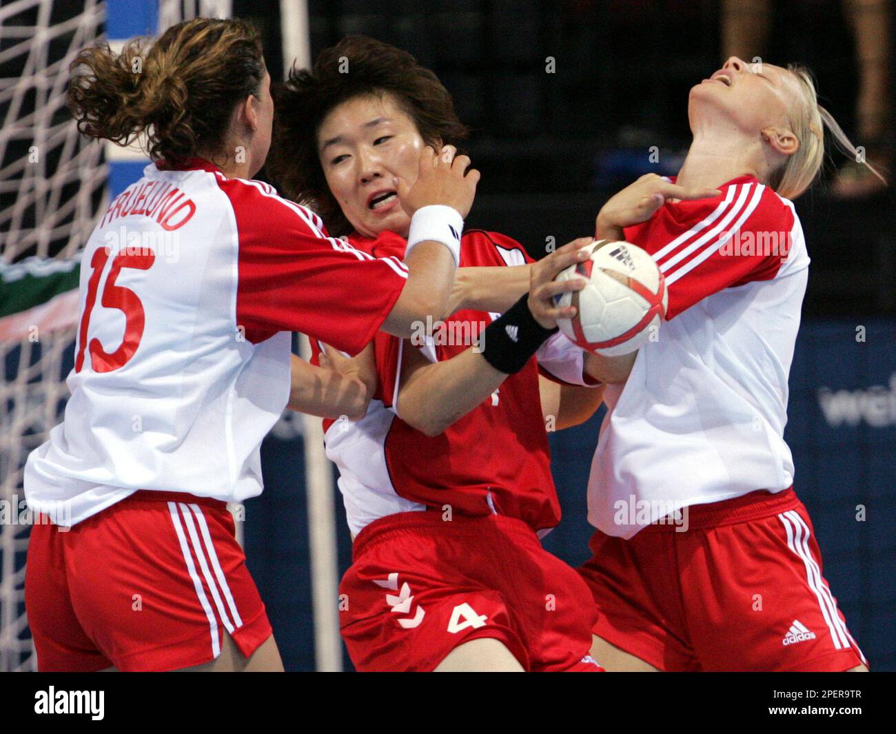 Korea's Soon Yung Huh, center, tries to make her way between Denmark's ...