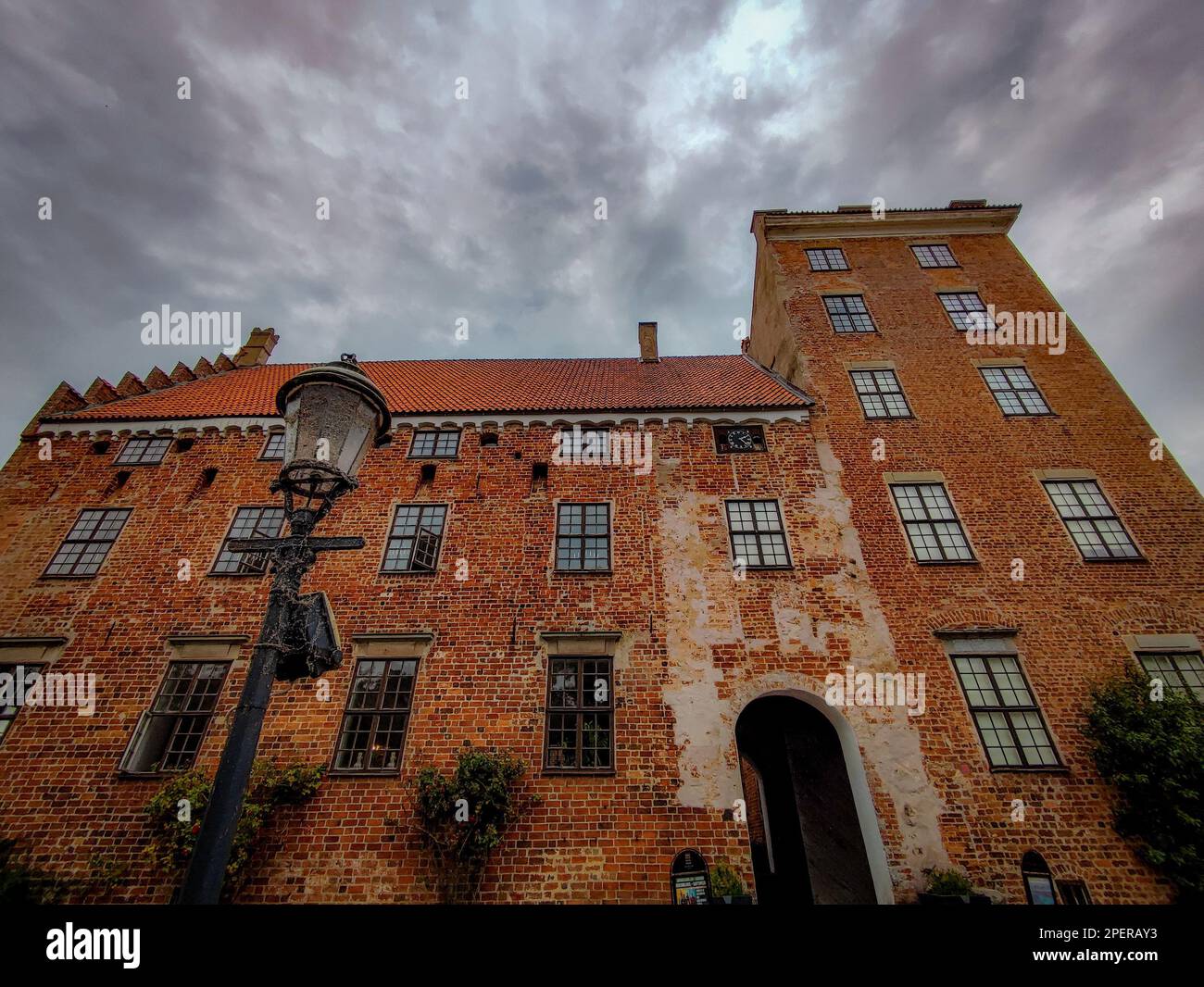 A low-angle shot of a brick facade of Svaneholm Castle against the ...