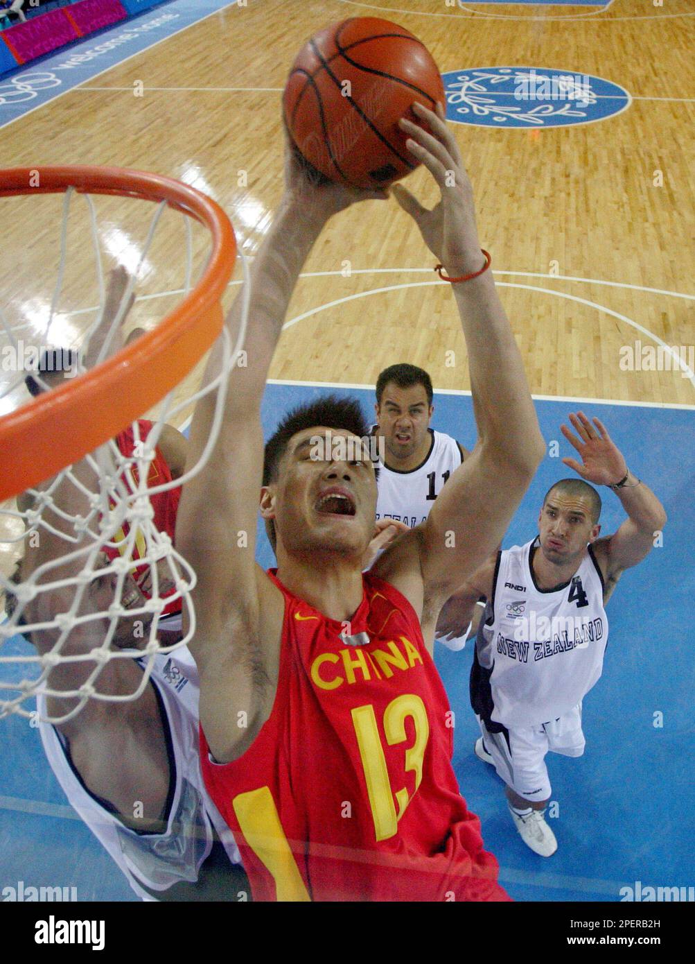 China's Yao Ming leaps high to shot above New Zealand defenders Sean ...