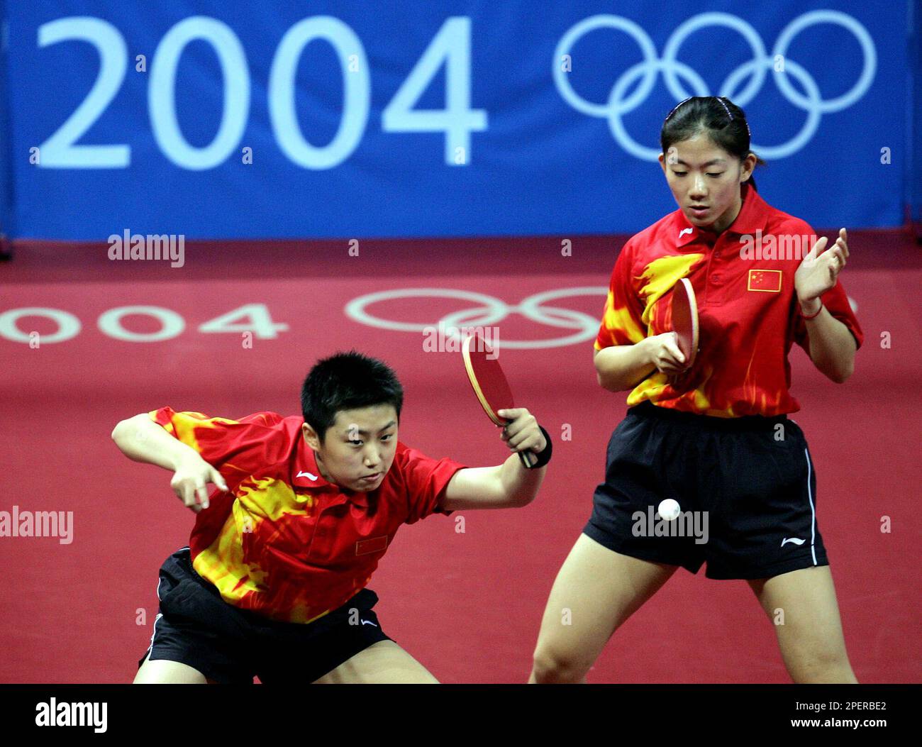 China's Guo Yue, left, returns a serve as her teamate Niu Jianfeng watching, against Chinese ...