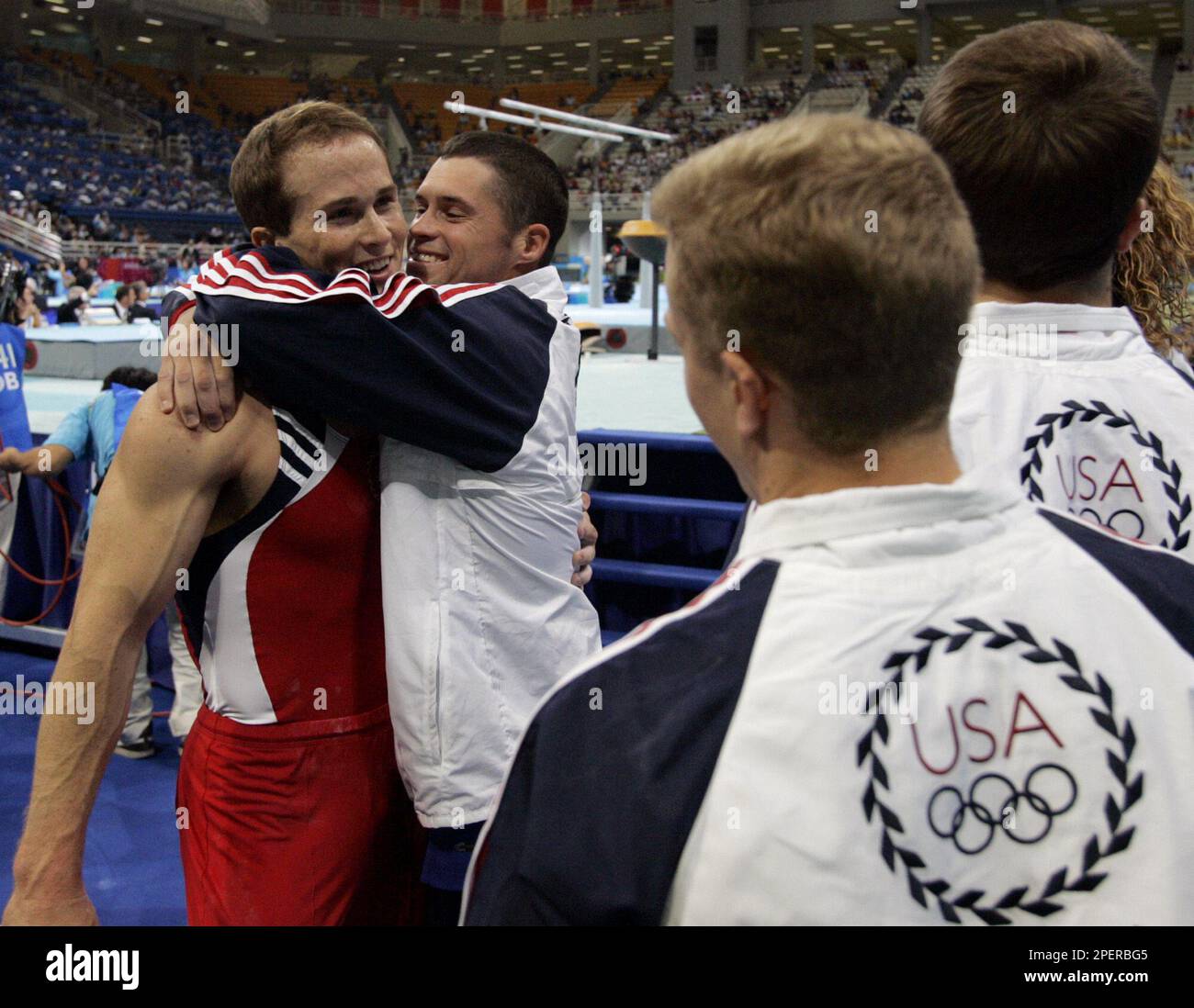 United States' Blaine Wilson, second right, hugs teammate Paul Hamm ...