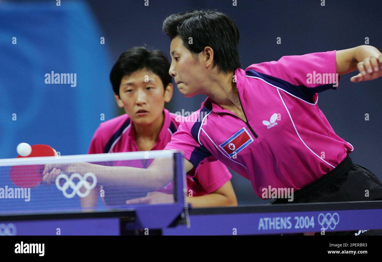 Kim Hyang Mi of DPR Korea, right, returns as her teammate Kim Hyon Hui ...