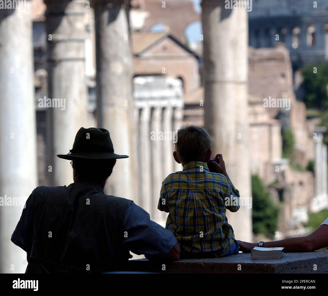 A father and son enjoy the view of the Romans forum in downtown Rome ...