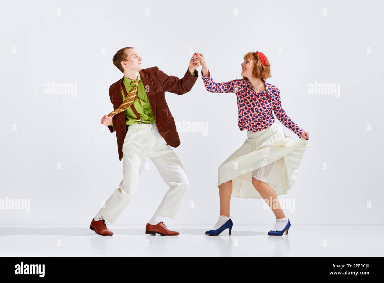 Showing positive energy. Young man and woman in stylish clothes dancing ...