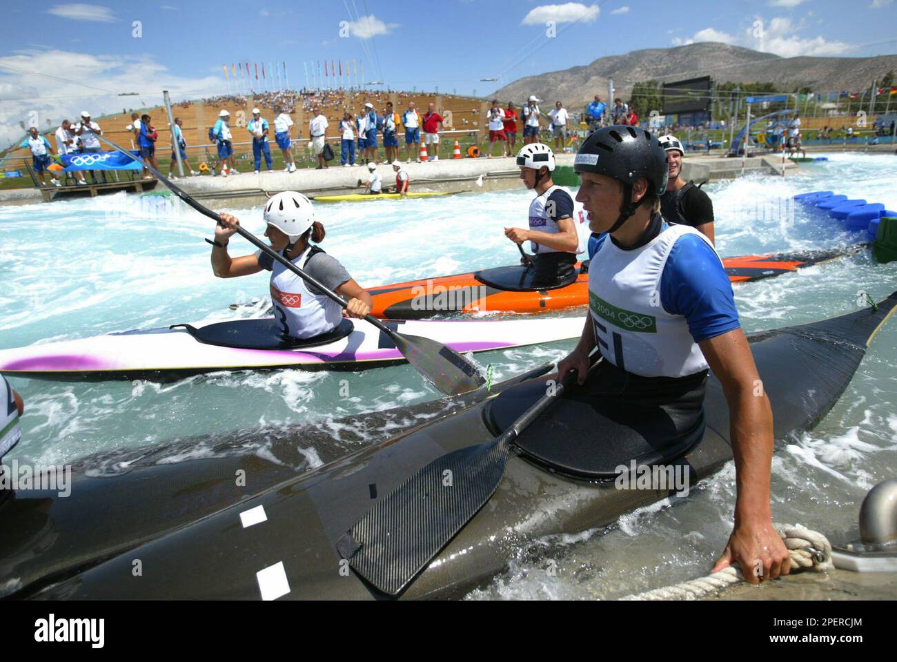 Athletes, trainers and other members of the teams watch as athletes ...