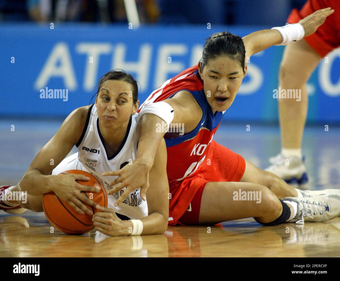 Korea's Kim Kwe Ryong, right, and New Zealand's Megan Compain dive to ...