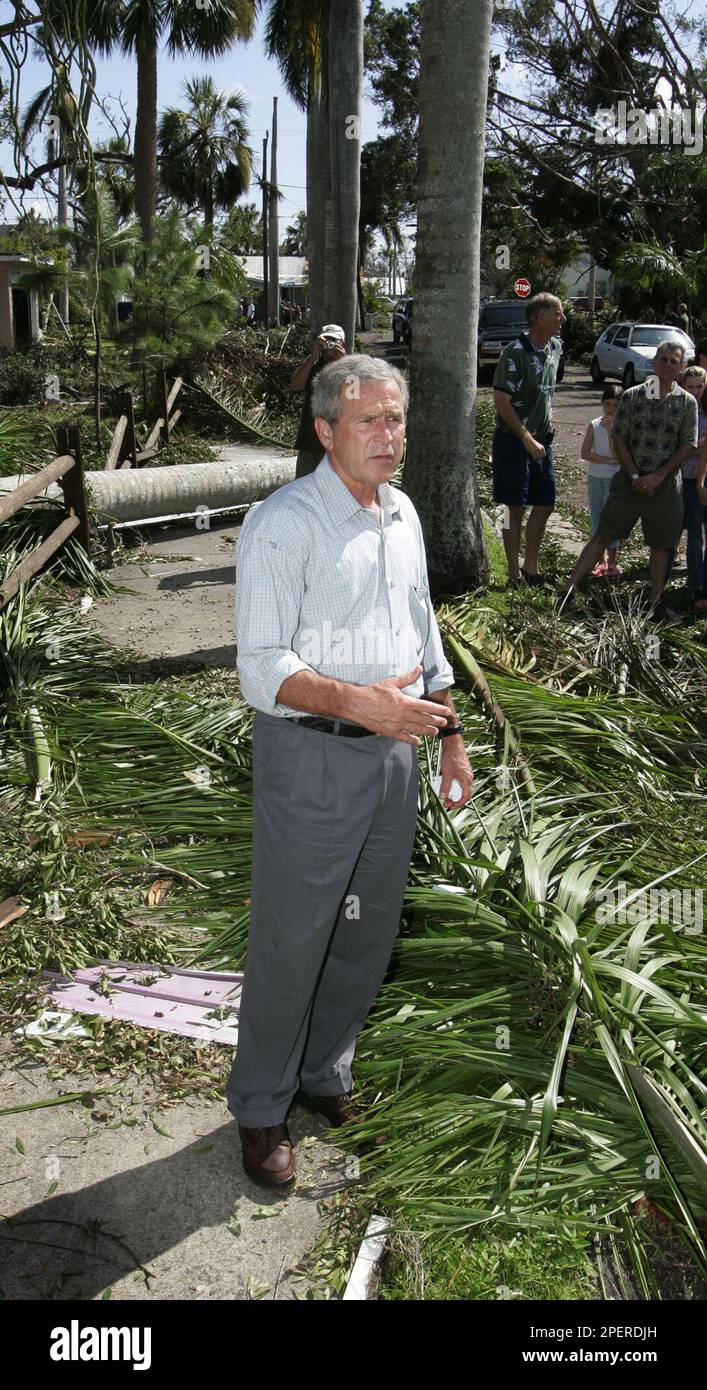 Standing amid fallen palm branches President Bush speaks to reporters ...