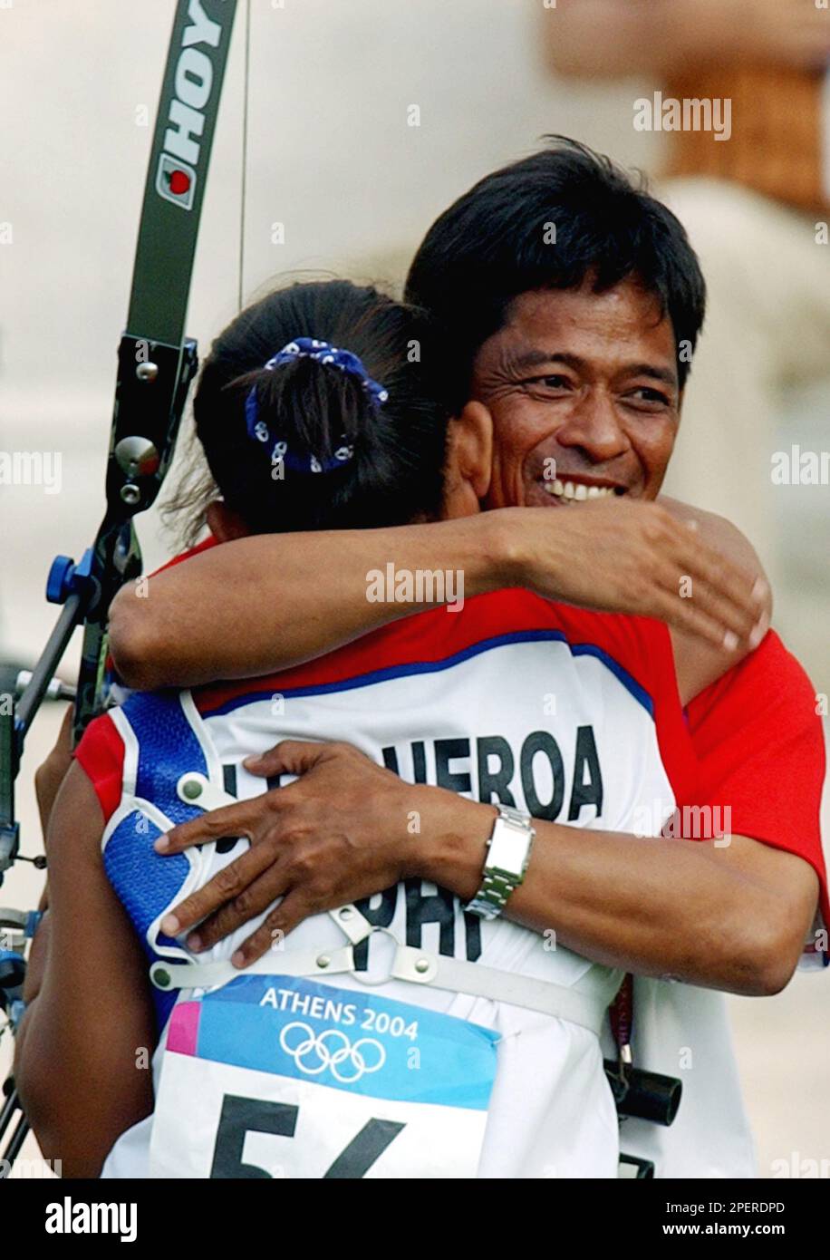 Jasmin Figueroa of the Philippines is hugged by her coach Henry Manalang after she upset Natalia ...