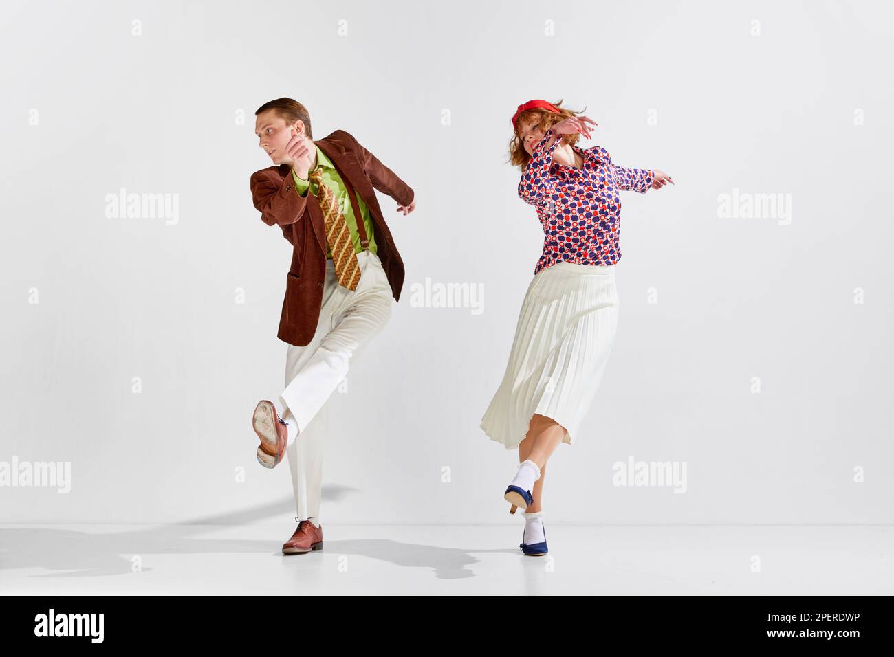 Boogie-woogie. Young man and woman in stylish clothes dancing retro ...