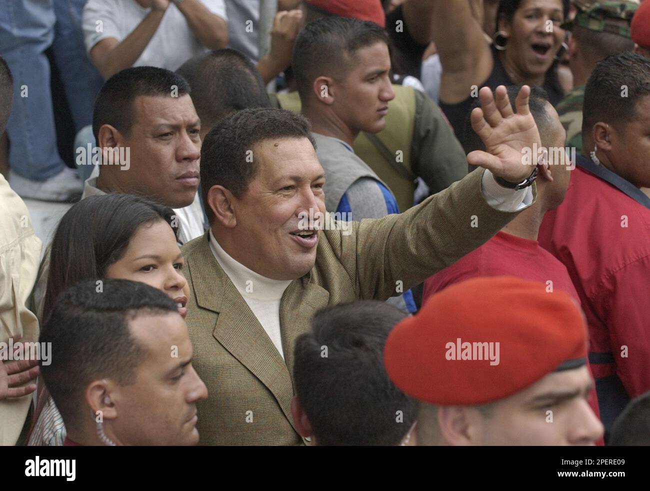 Venezuelan President Hugo Chavez waves after casting his vote during ...