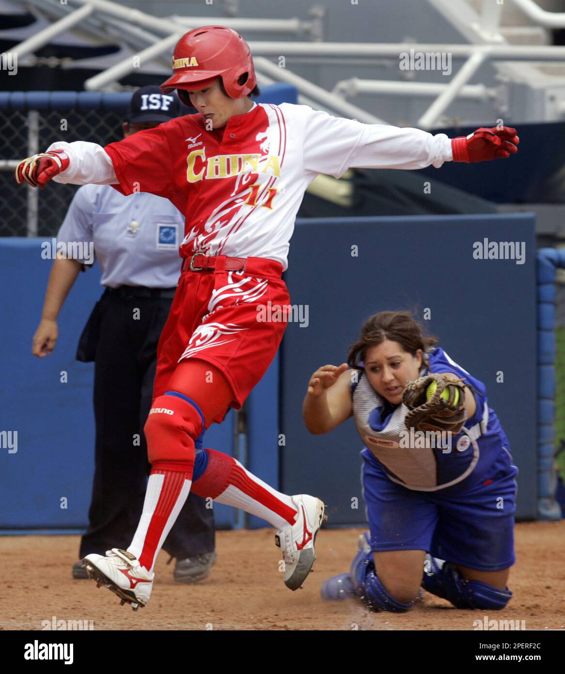 China's Mu Xia crosses home ahead of the tag by Italy catcher Natalie ...