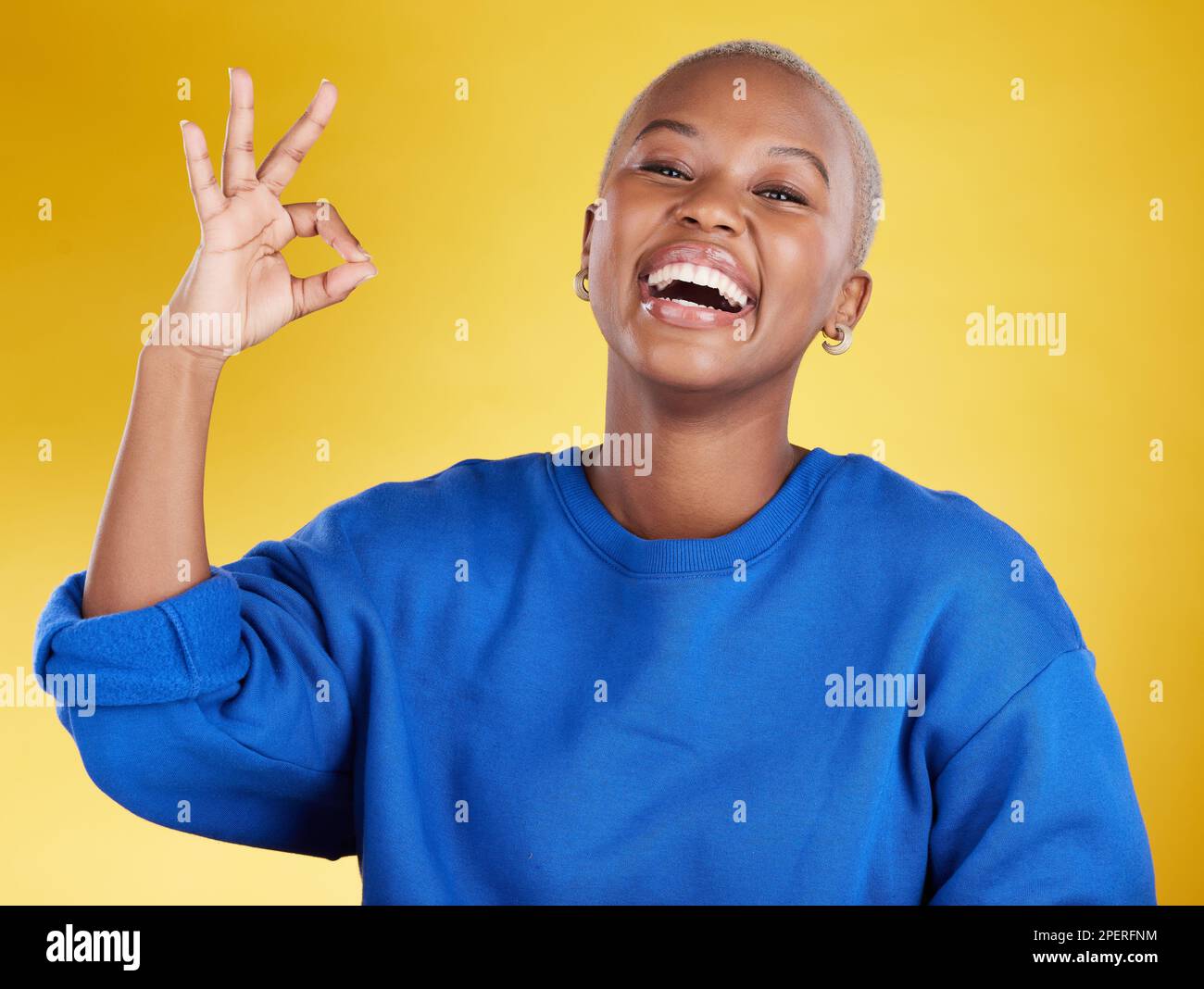 Portrait, laughing and black woman with ok sign in studio isolated on a ...