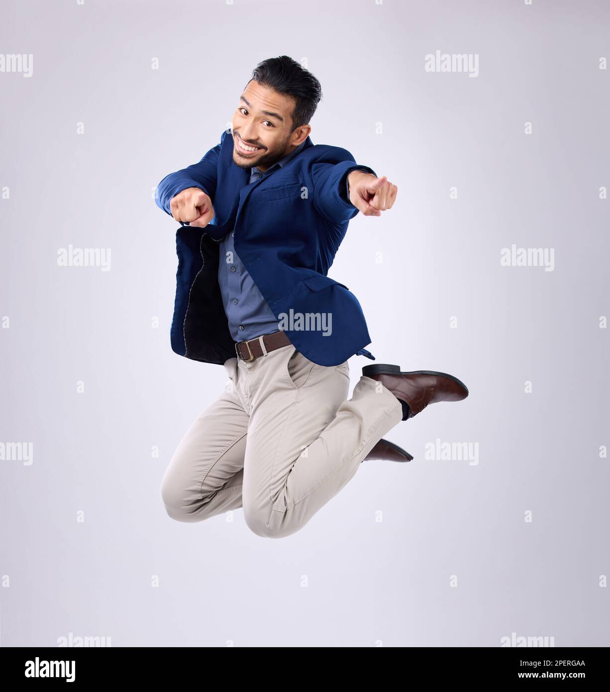 Jump, excited and portrait of man point in studio with surprise ...