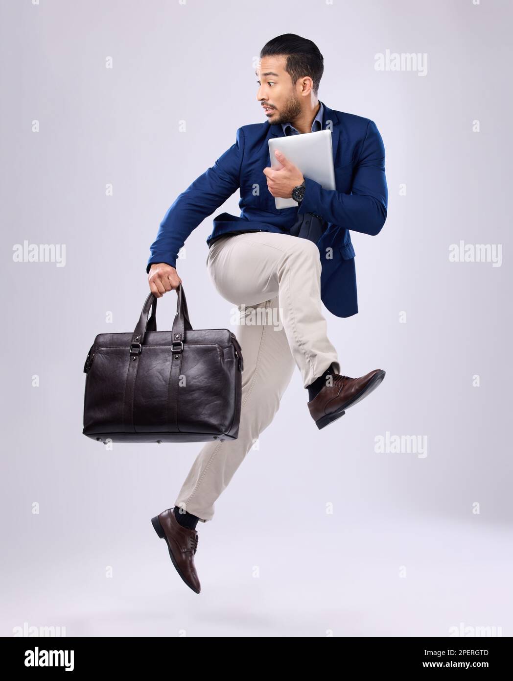 Late, work and an Asian man jump for business isolated on a white ...