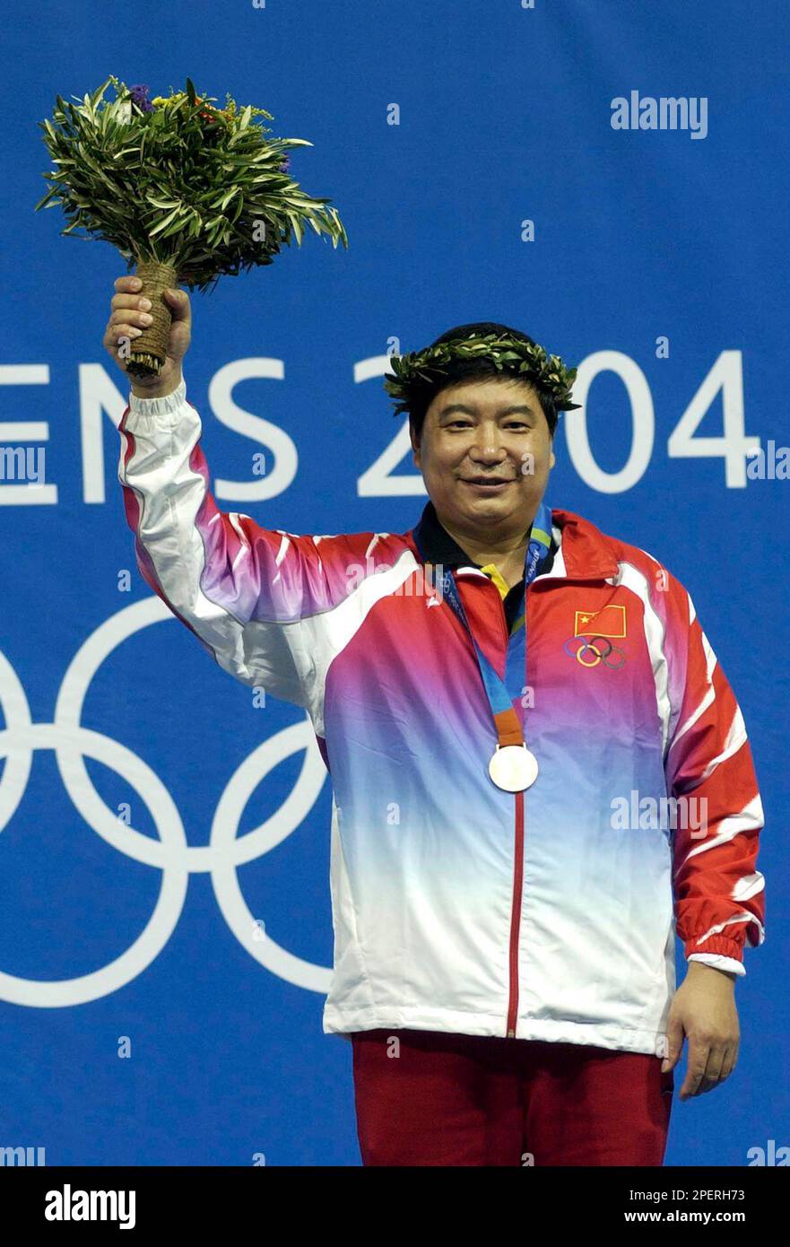 China's Yifu Wang stands on the podium after winning the gold medal in ...
