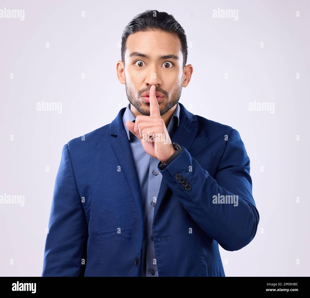 Portrait, corporate man and finger on lips in studio, background and privacy secret. Male ...