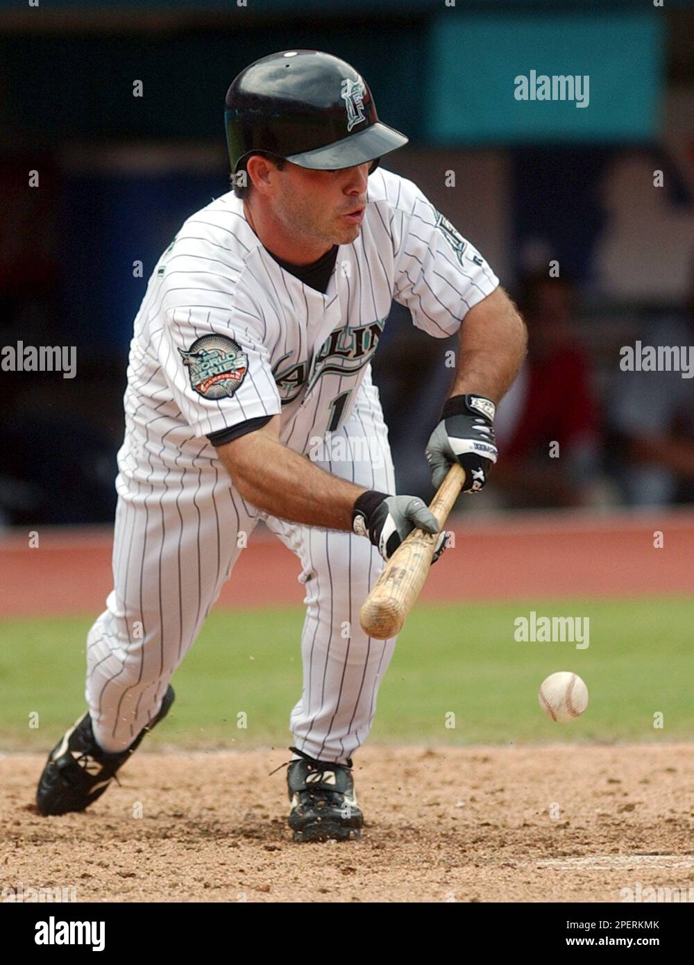 Florida Marlins pinch hitter Mike Mordecai bunts for and infield single ...