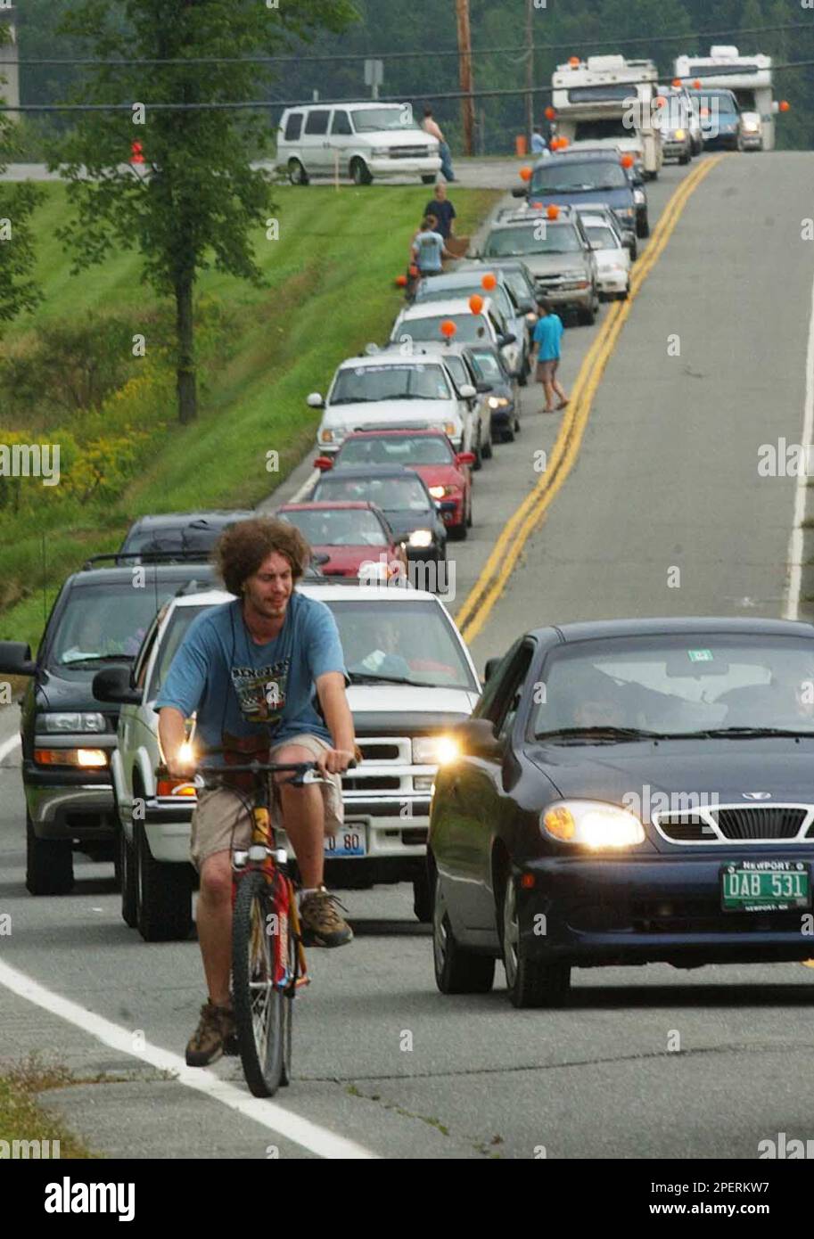 Phish fans wait in line on the access road in Coventry, Vt., on their ...