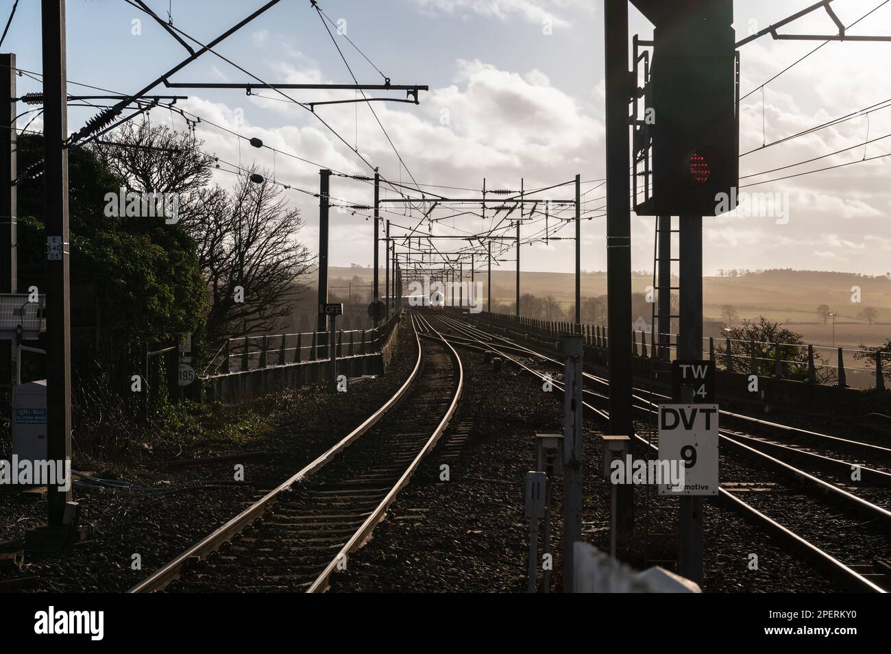 Train arriving out of the sun at Berwick Upon Tweed station ...