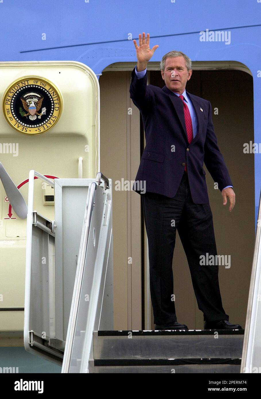 President Bush waves to a group of well-wishers as he boards Air Force ...