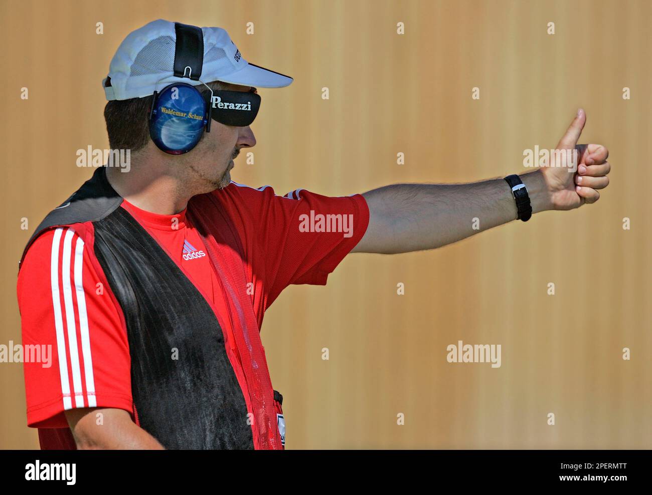 Waldemar Schanz, of the German shooting team, uses his thumb during men ...