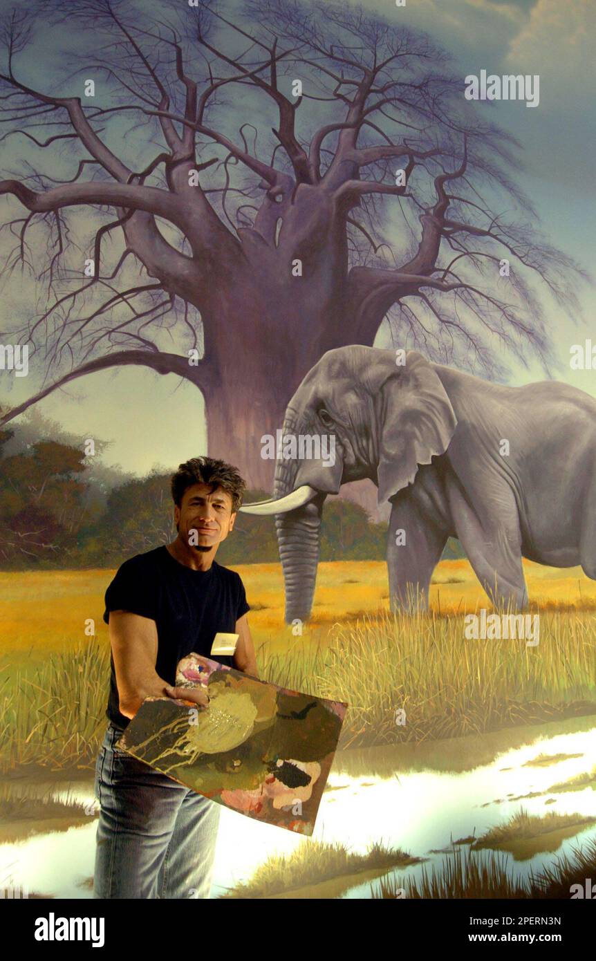 Artist Paul Manktelow poses in front of his mural in the African ...