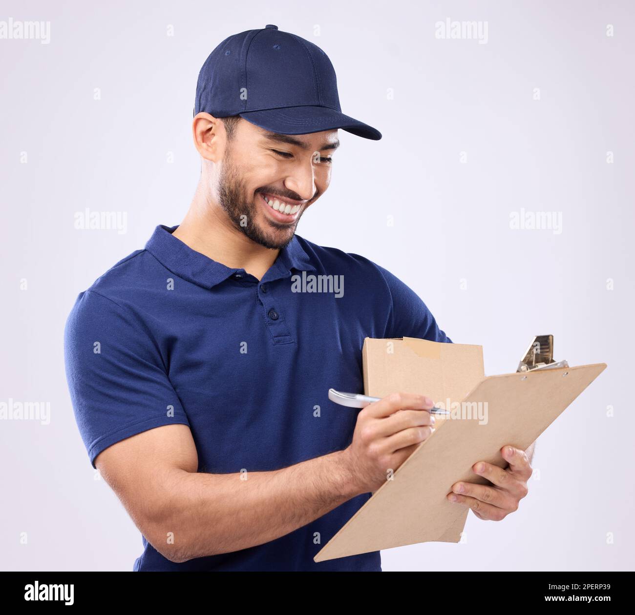 Delivery man writing on checklist isolated on studio background in ...