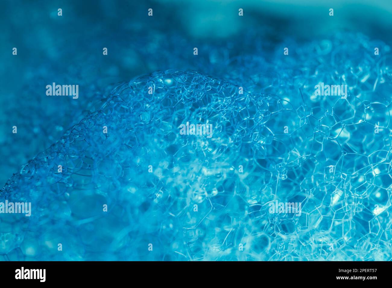 A closeup of blue translucent soap bubbles floating on the water ...