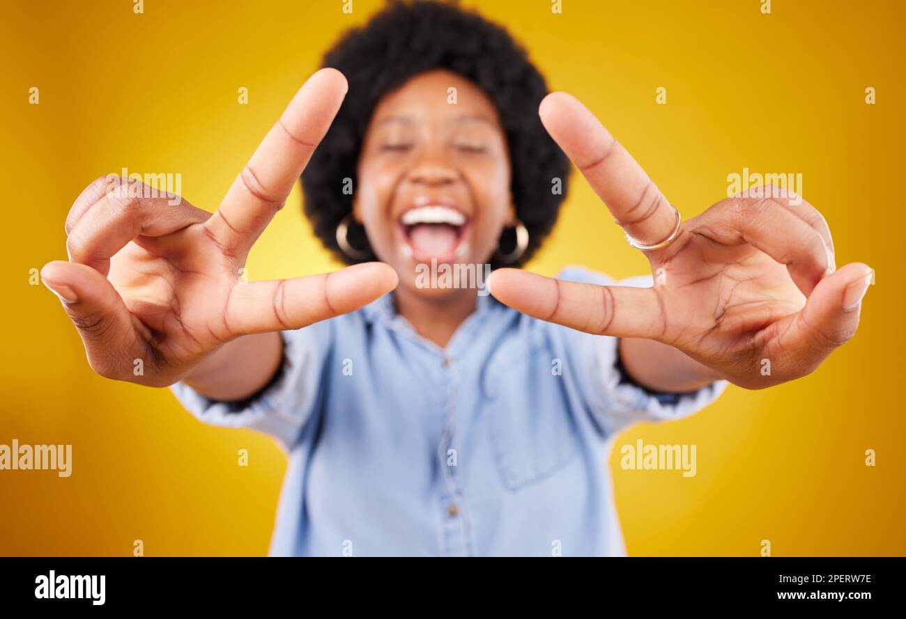 Happy, excited and black woman with a peace sign in studio with ...