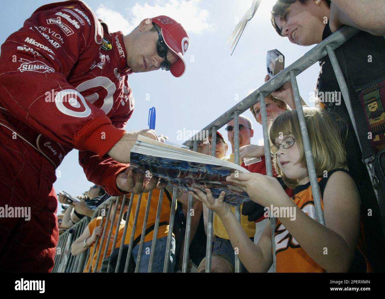 MASCAR driver Casey Mears signs an autograph for Courtney Black of ...