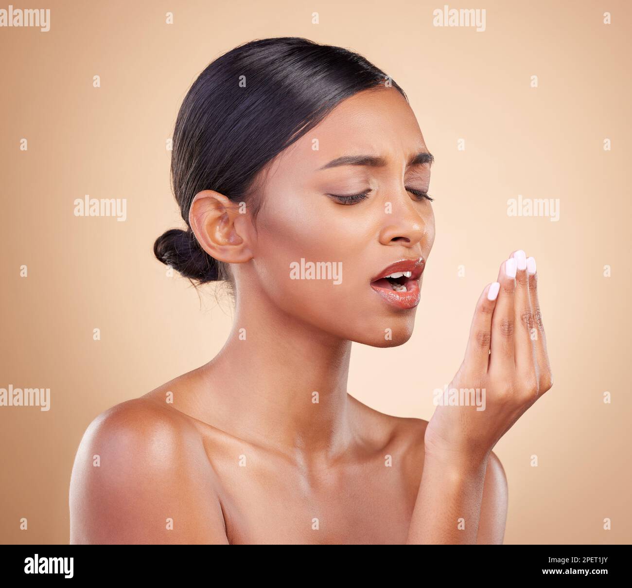 Hand, woman and breath check in studio for hygiene, dental or wellness ...