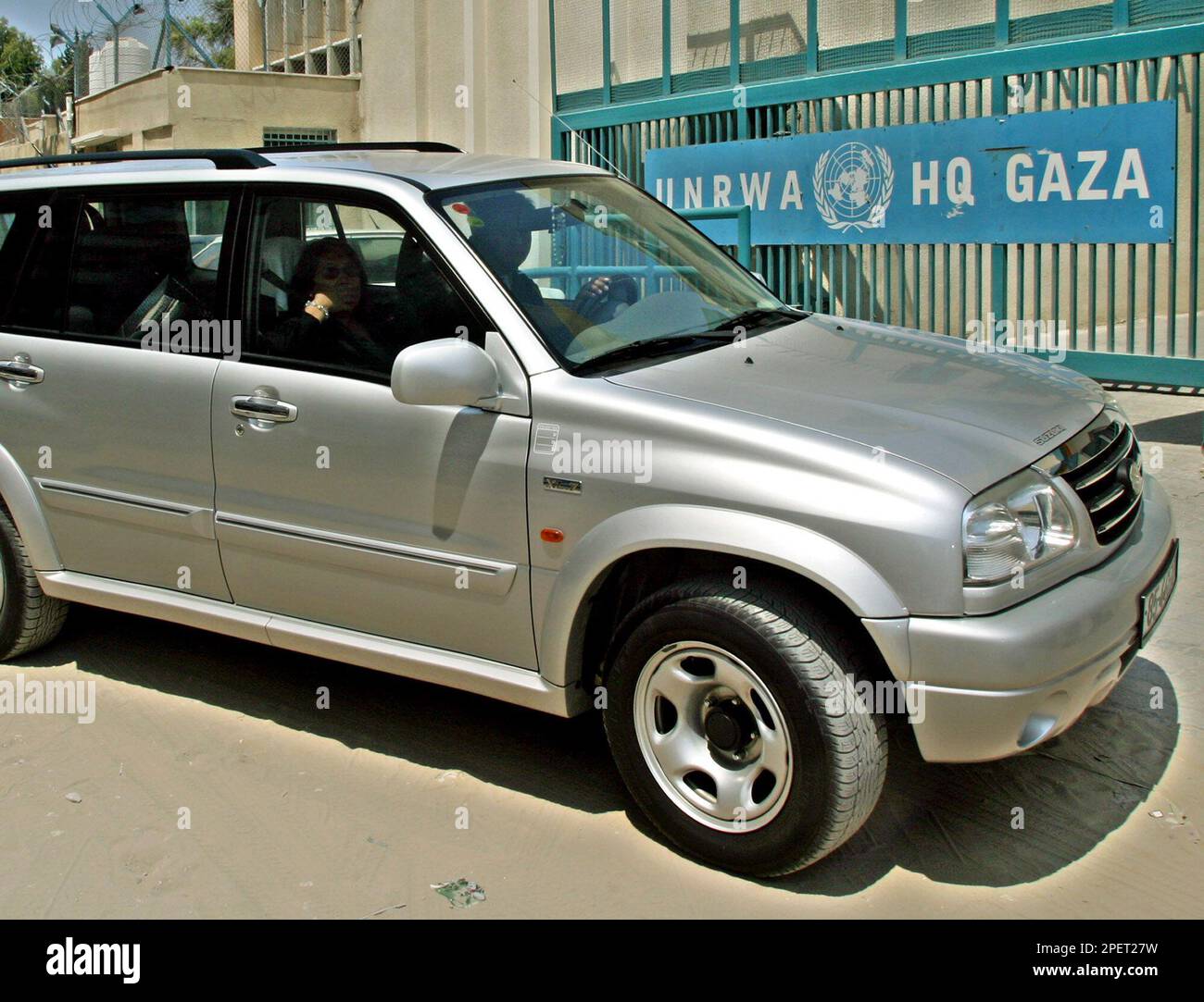 Unidentified United Nations workers in their car leave the United ...