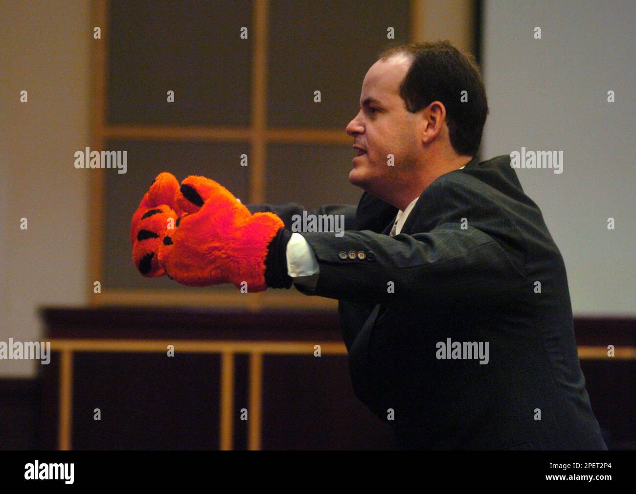 Attorney Jeff Kaufmann, right, wears the gloves from a Tigger costume ...