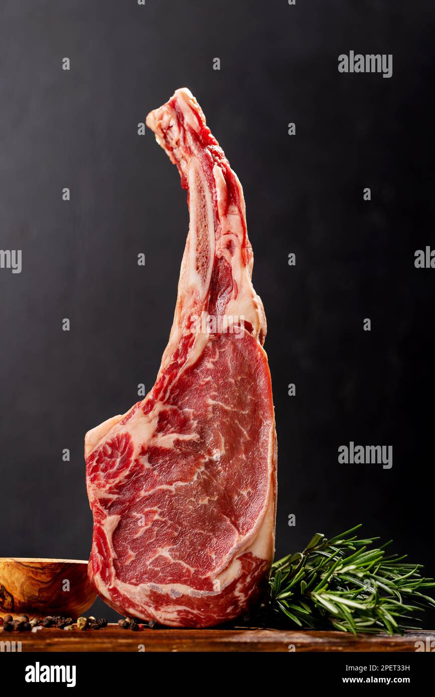 Raw Tomahawk beef steak and spices. Ready for grilling Stock Photo - Alamy
