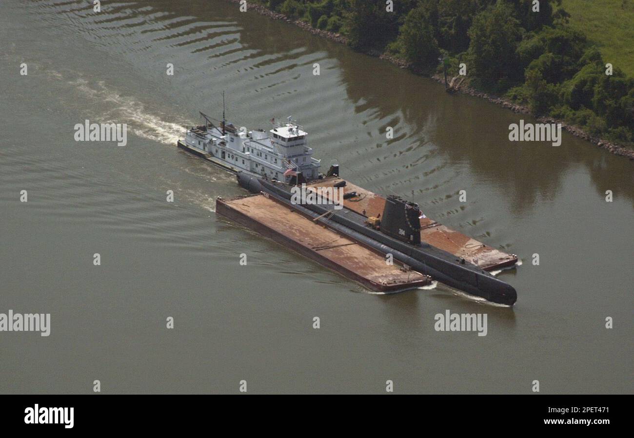 The USS Razorback is pushed by tug boat up the Arkansas river Tuesday ...