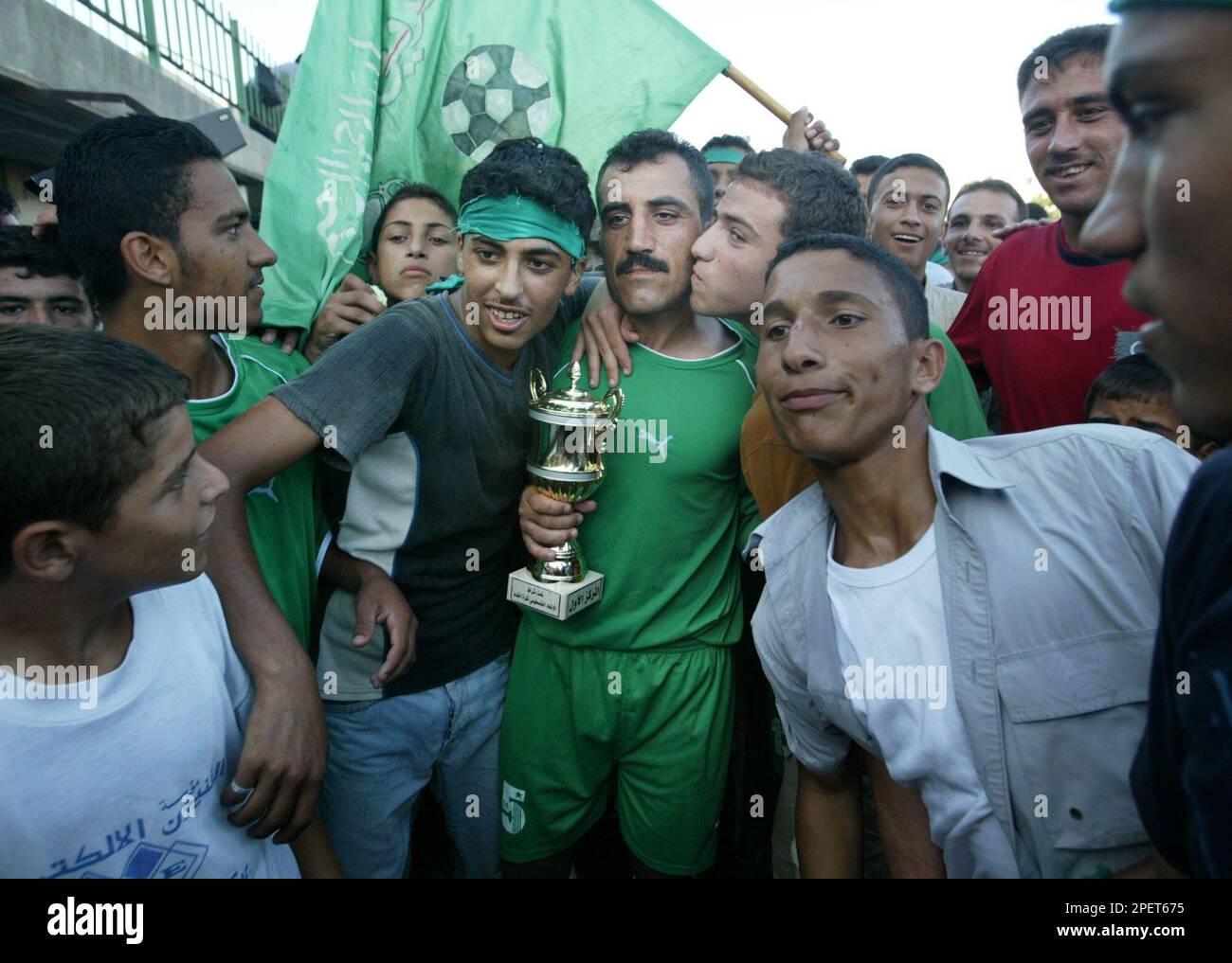 A Palestinian soccer player, center, from Shajiah in the northern Gaza ...