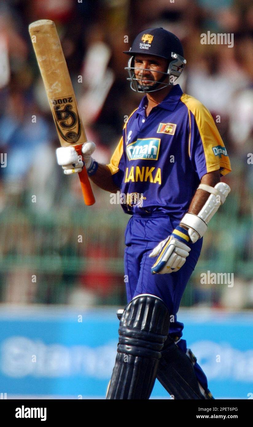 Sri Lankan captain Marvan Atapattu raises his bat after scoring his ...