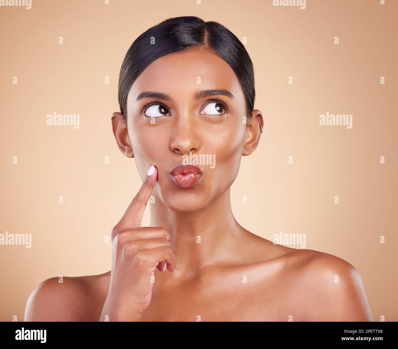 Indian woman, skincare and hand for thinking in studio with face ...