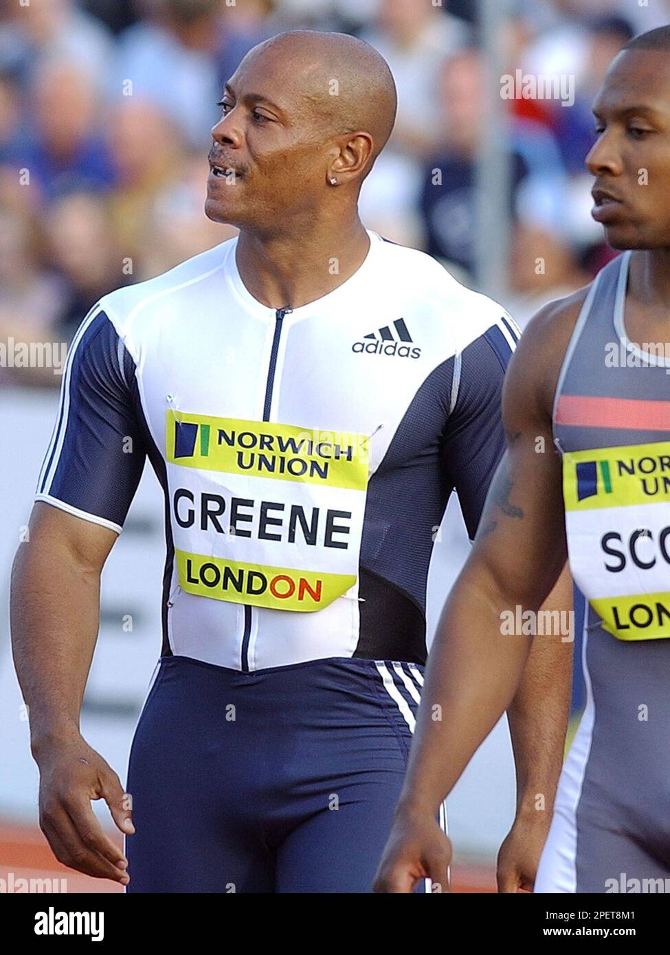 U.S. sprinter Maurice Greene, left, looks dejected after coming second ...