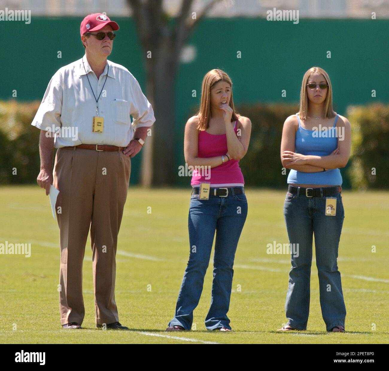 San Francisco 49ers owner John York, left, watches practice with his twin daughters, Mara ...