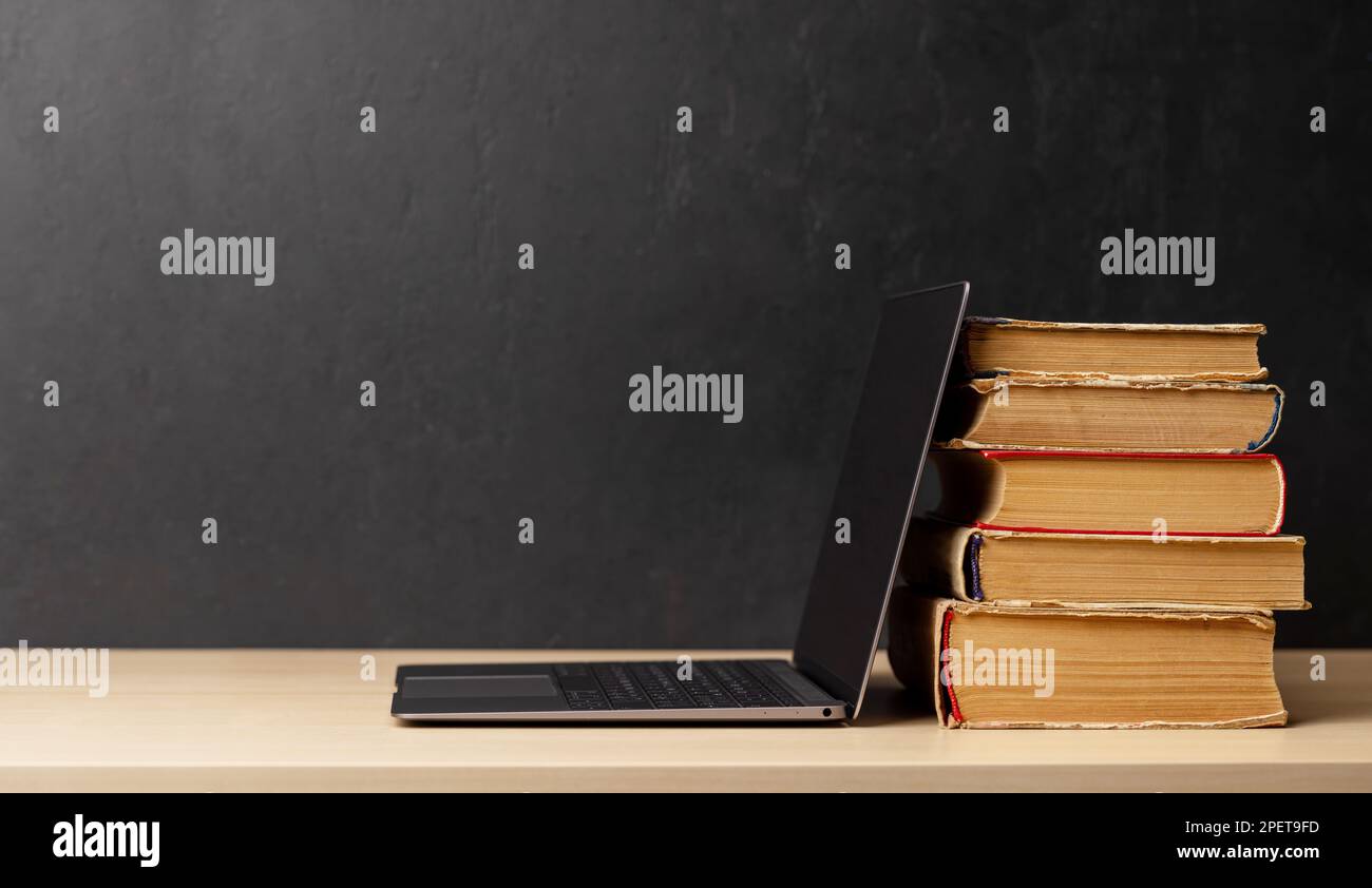 Laptop stack books textbook hi-res stock photography and images - Alamy